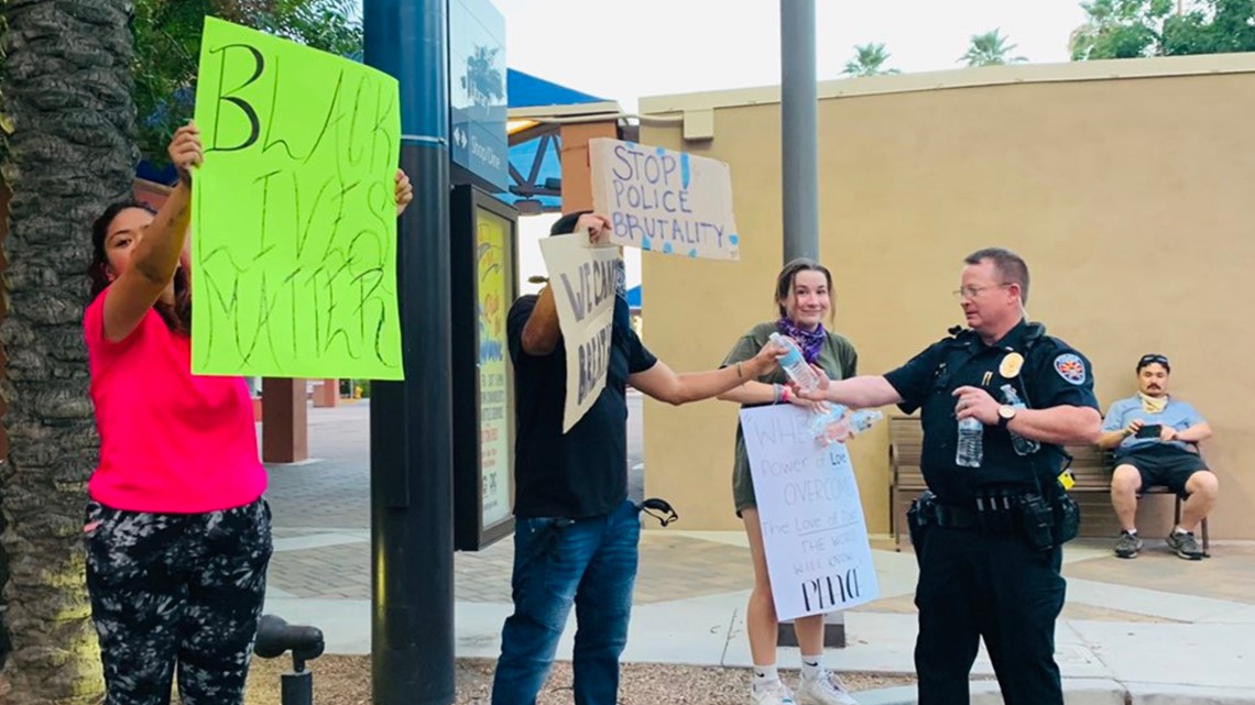 Chandler police officer hands out water to protesters | 12news.com