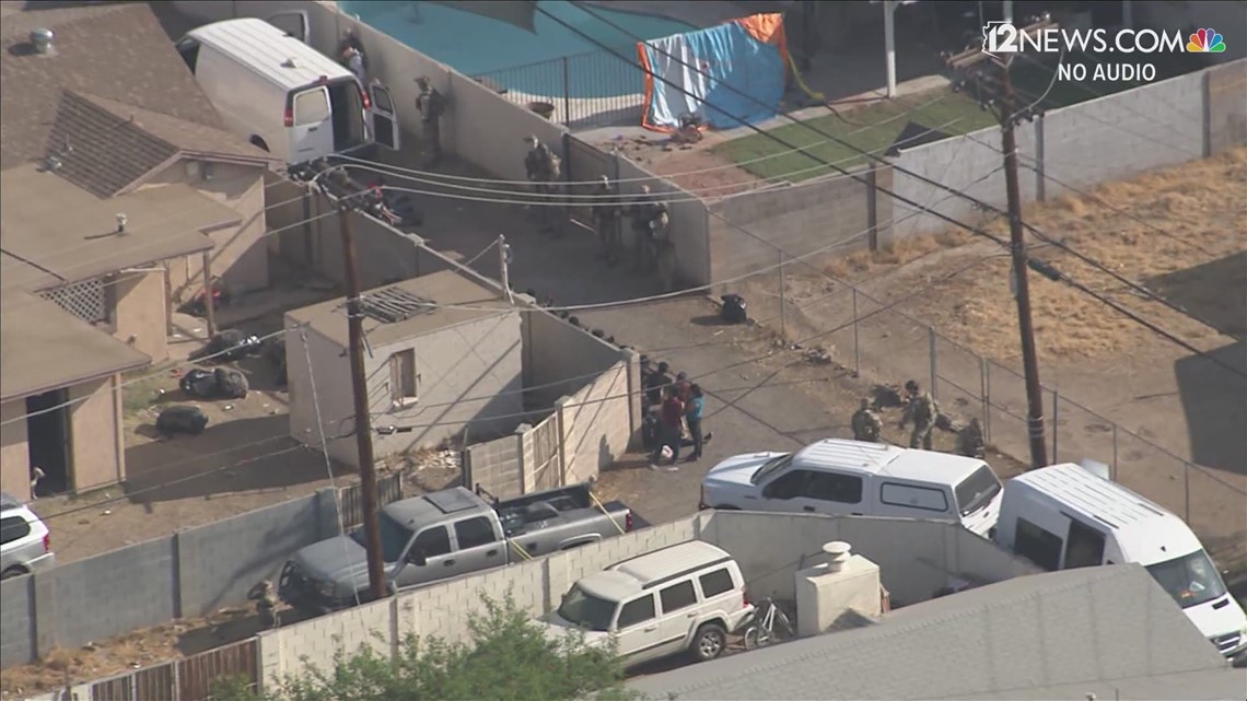 Large police presence with dozens on street outside Phoenix home ...