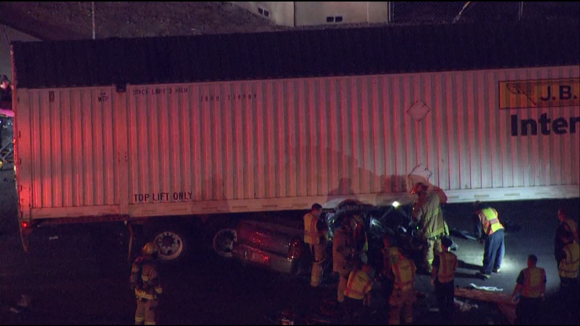 Sedan trapped under semi-truck trailer in Glendale | 12news.com