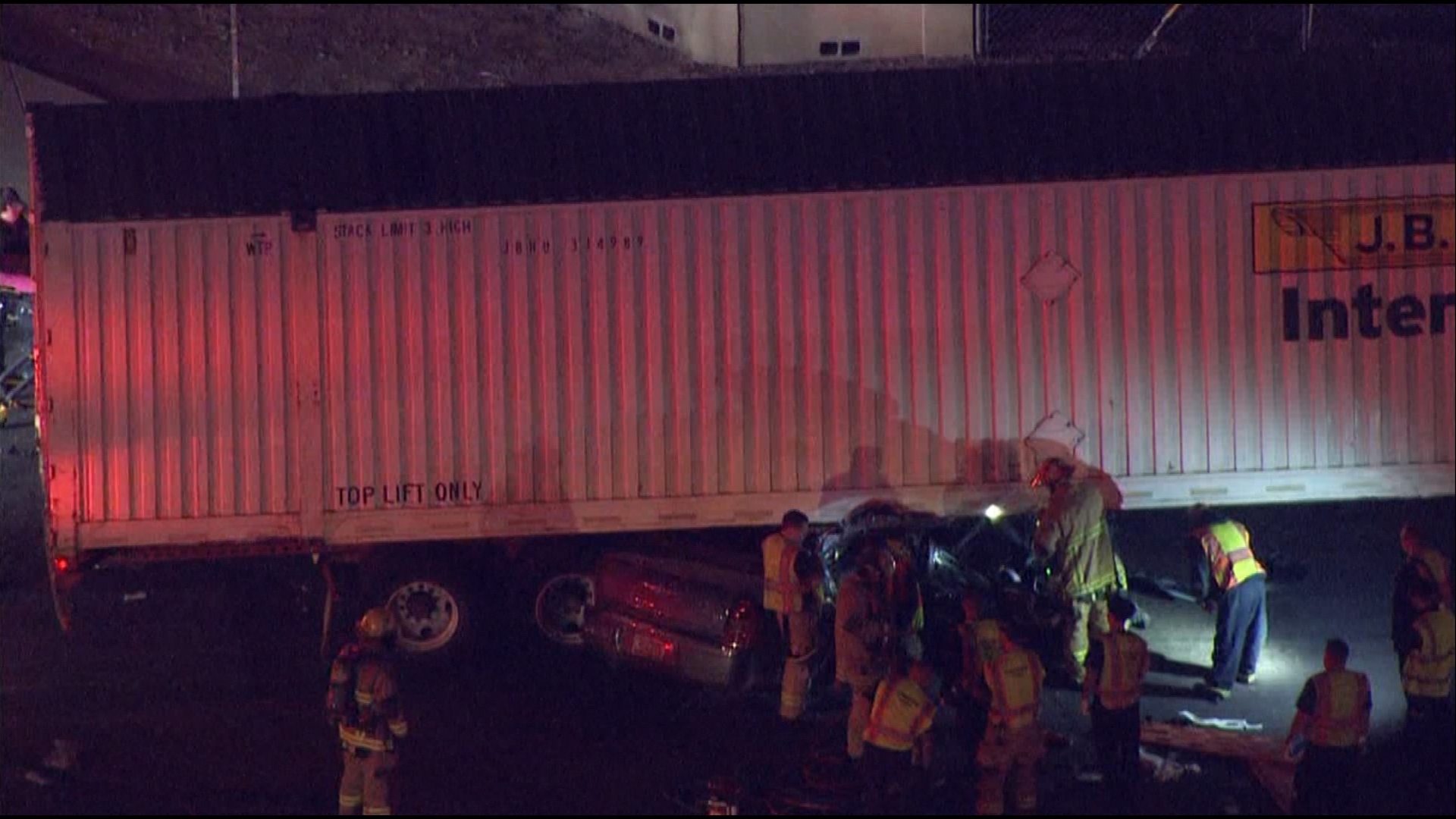 Sedan trapped under semi-truck trailer in Glendale | 12news.com