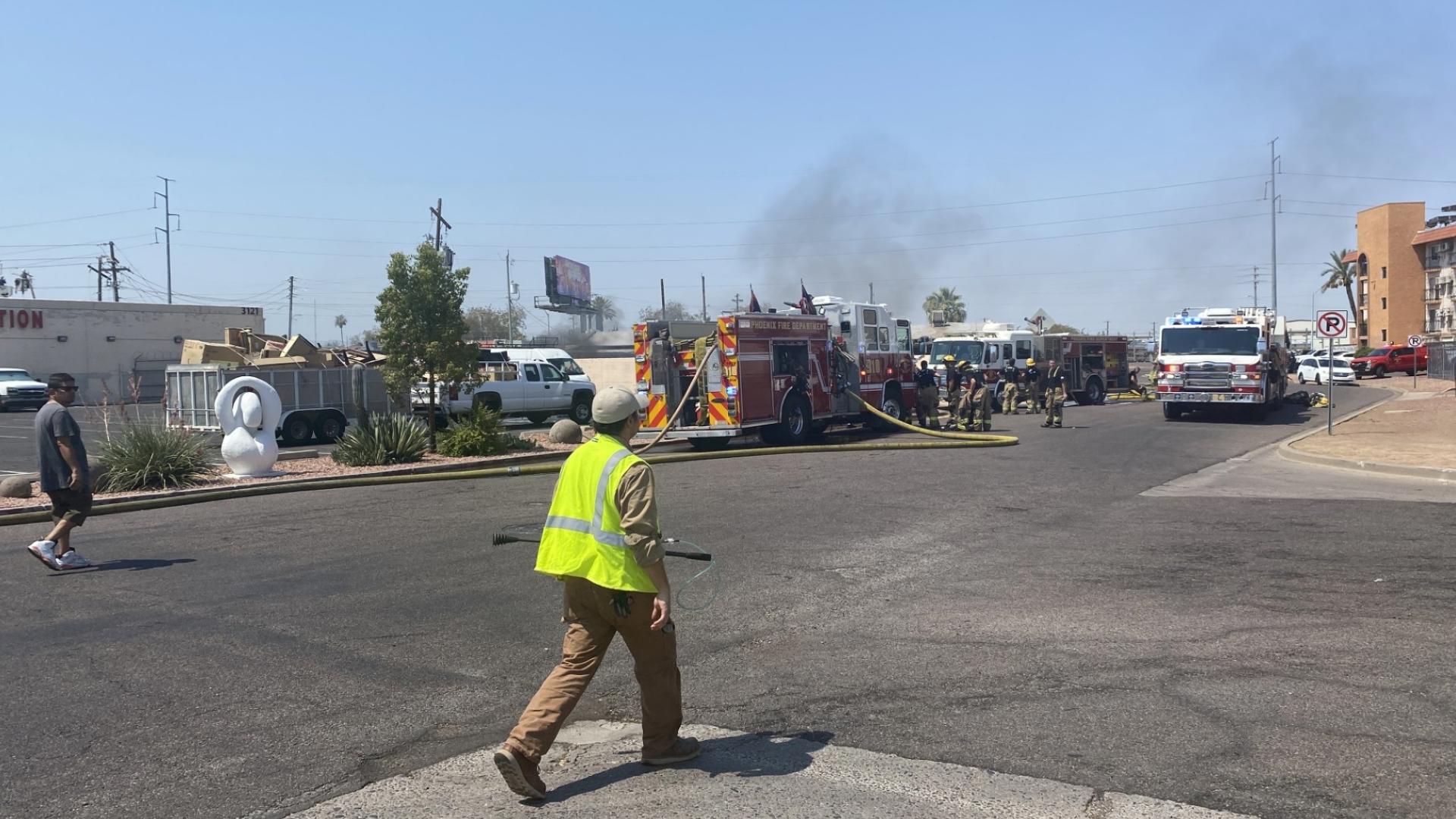 Structure fire in west Phoenix burns 15 cars | 12news.com